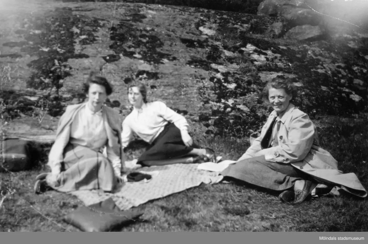 De tre systrarna Lindblom sittandes på filtar utomhus, 1930-tal ...